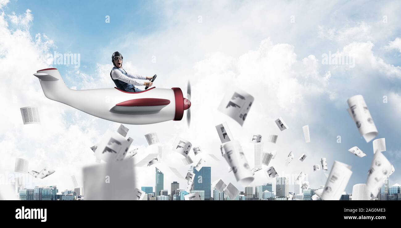 Businessman in aviator hat driving plane Stock Photo - Alamy