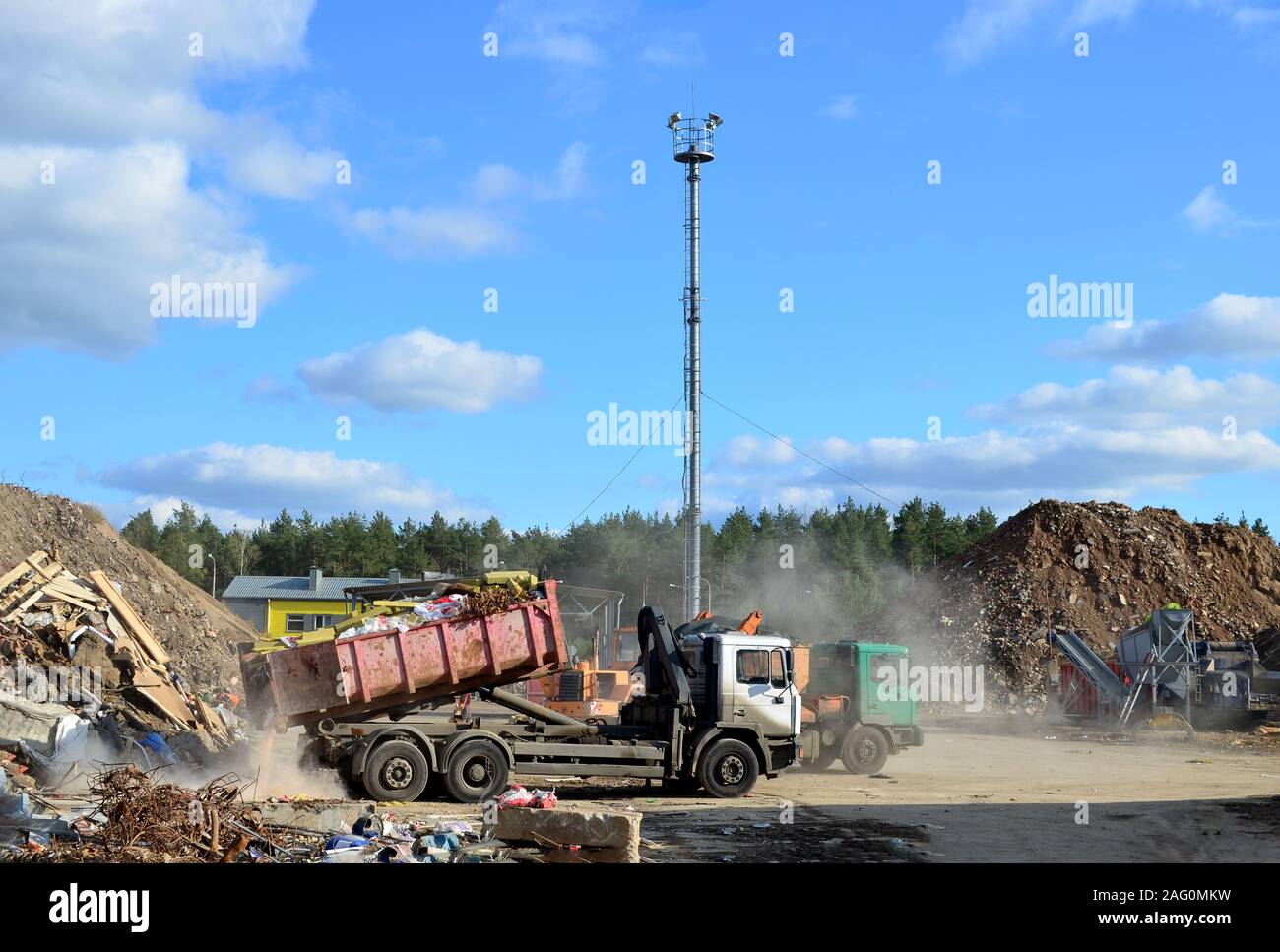 Garbage truck unloads construction waste from container at the landfill ...