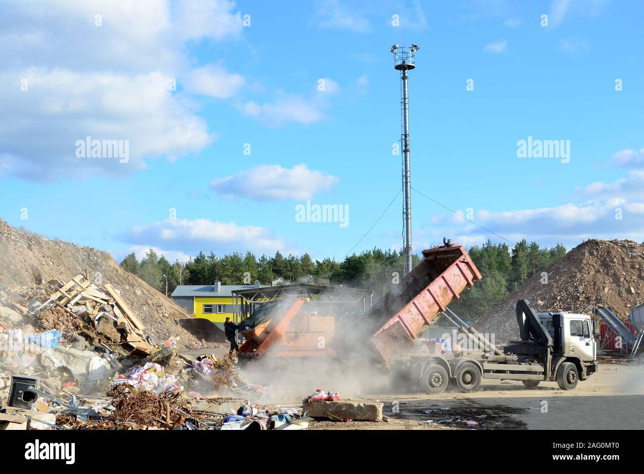 Garbage truck unloads construction waste from container at the landfill ...