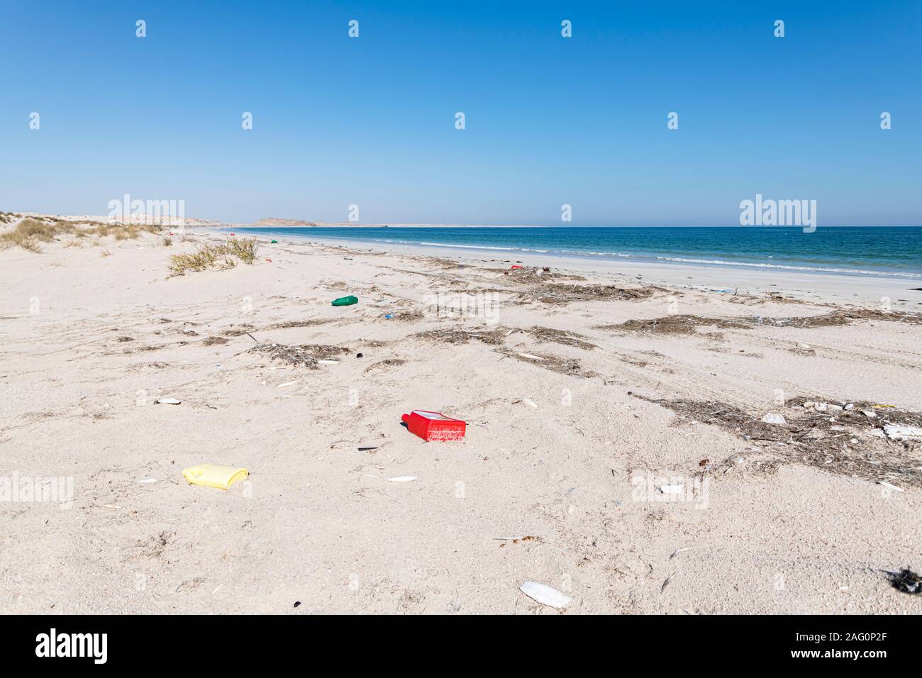 Garbage on the beach from the sea (with many plastic bottles ...