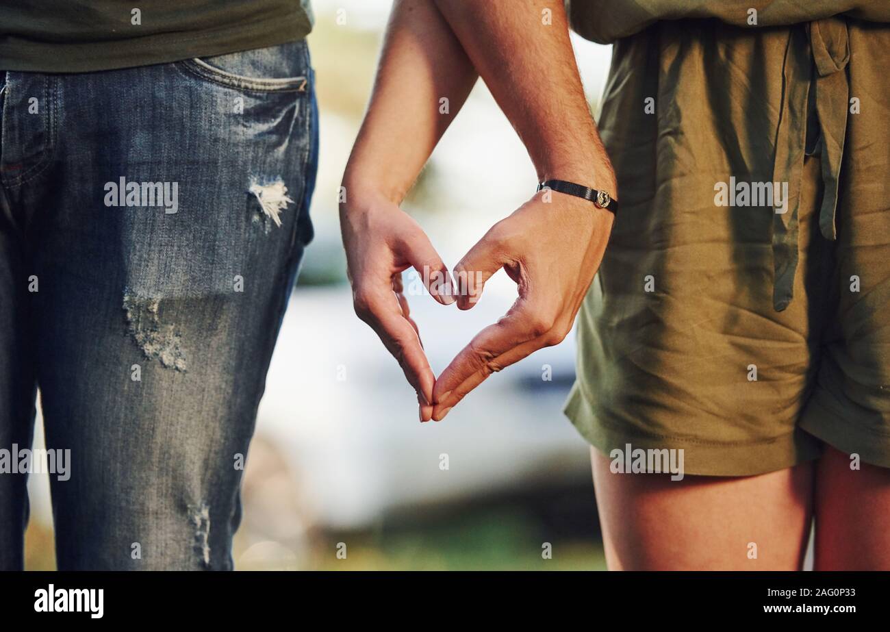 Making heart and love gesture by the hands. Young couple have a good ...