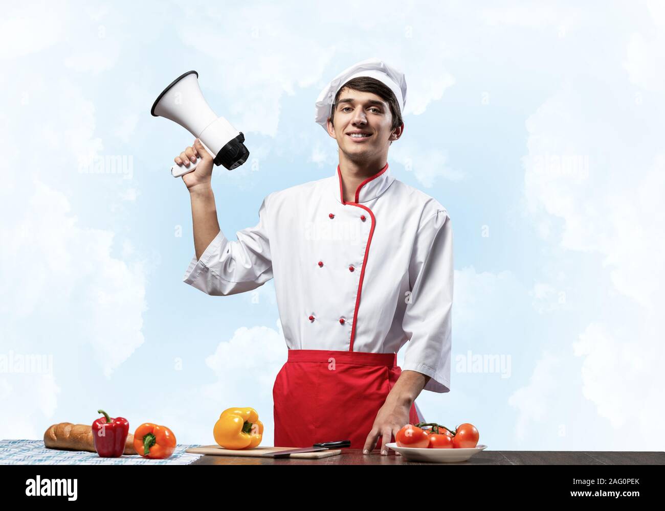 Young chef standing with megaphone in hand Stock Photo - Alamy
