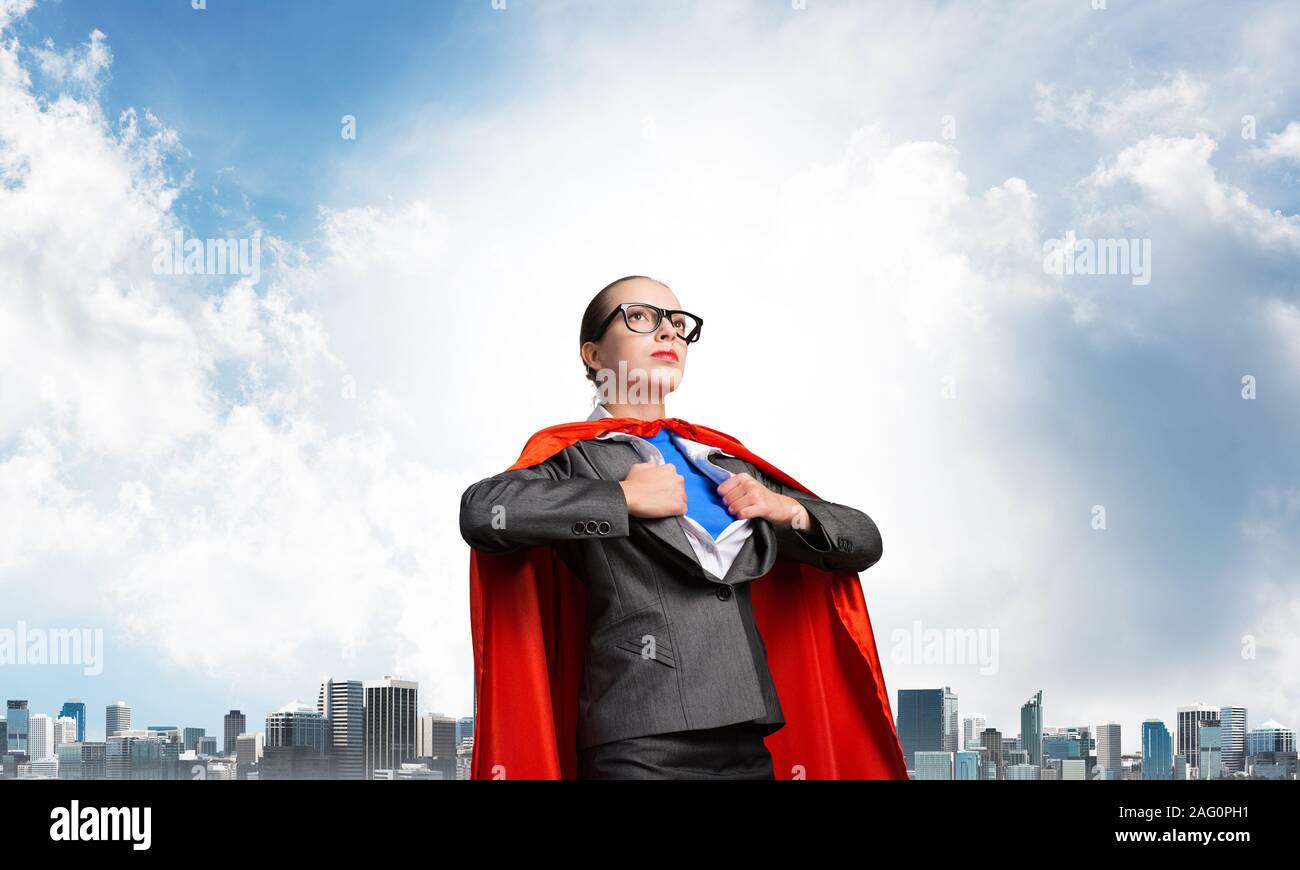 Serious business lady in red hero cape Stock Photo - Alamy