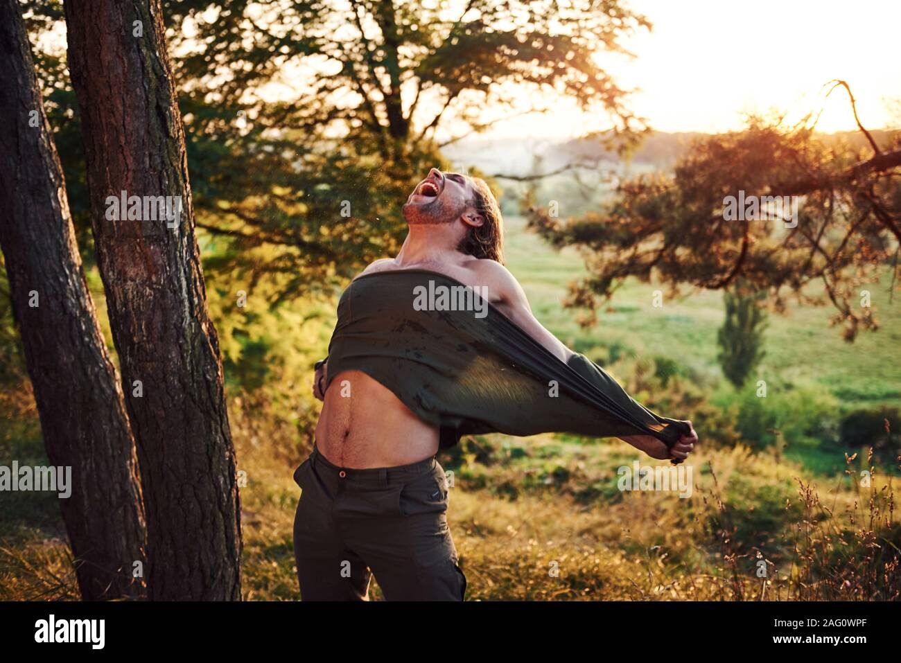 Screaming and tearing the shirt. Conception of freedom. Beautiful man ...