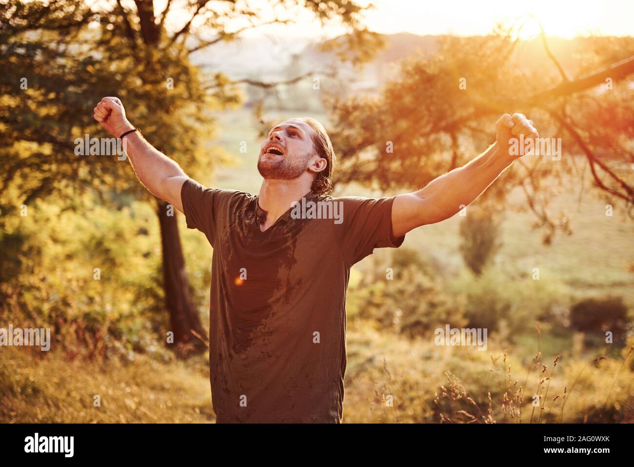Conception of freedom. Beautiful man in the forest. Good weather ...