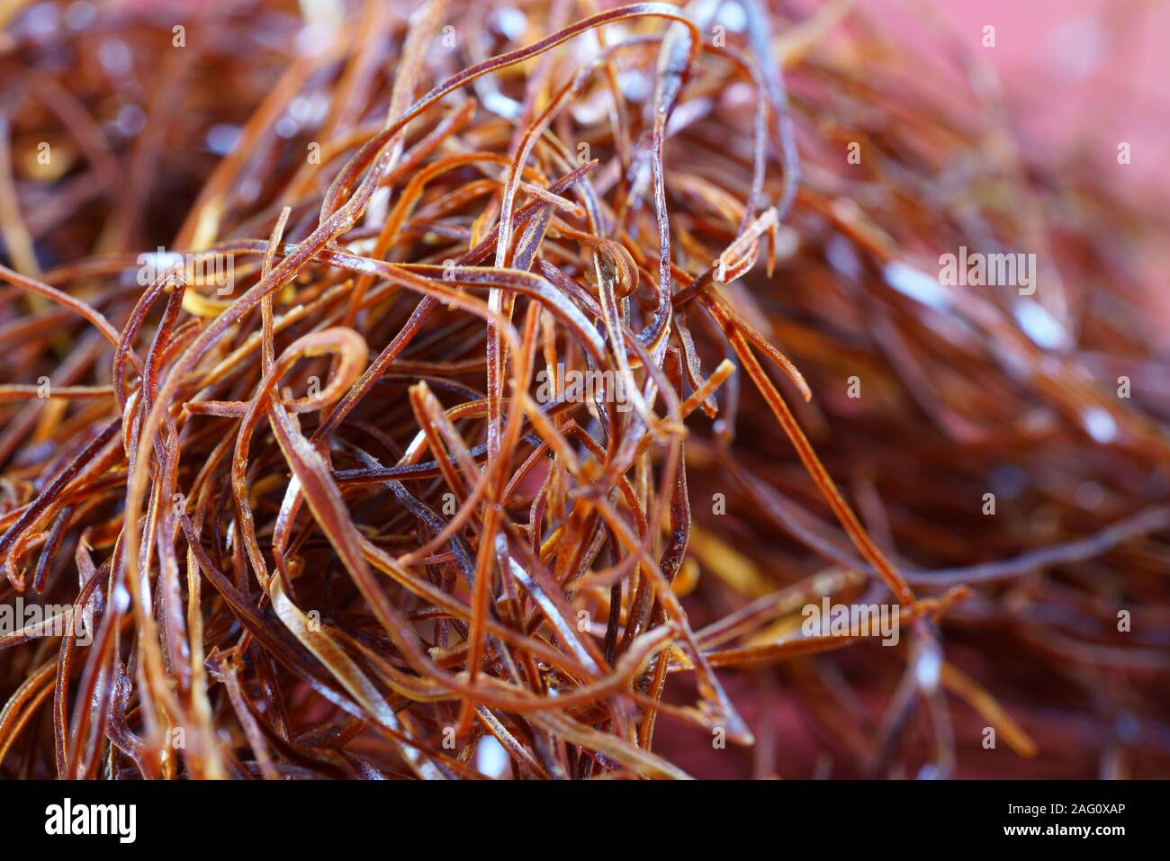 Chilli spice in strips and as grains photographed in the studio as a ...
