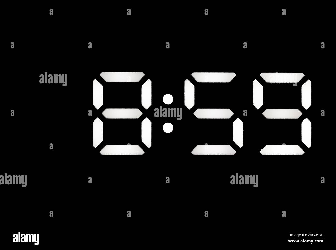 Real white led digital clock on a black background showing time 8:59 ...