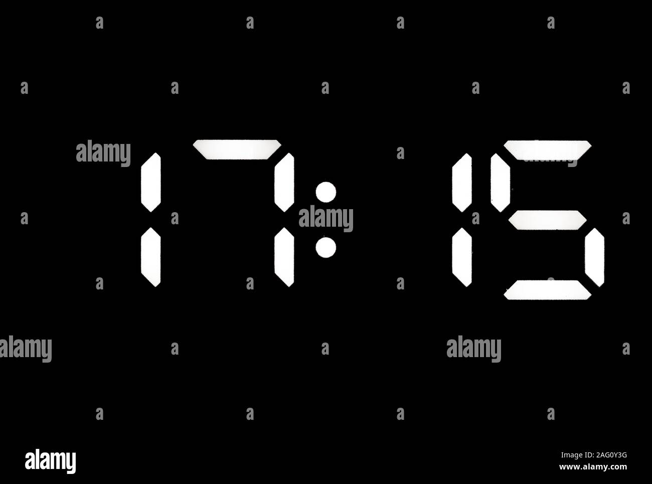 Real white led digital clock on a black background showing time 17:15 ...