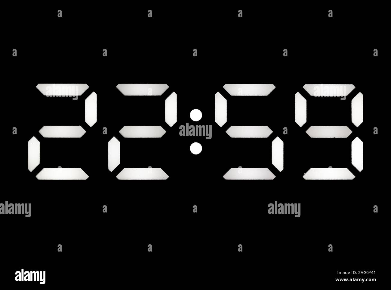 Real white led digital clock on a black background showing time 22:59 ...