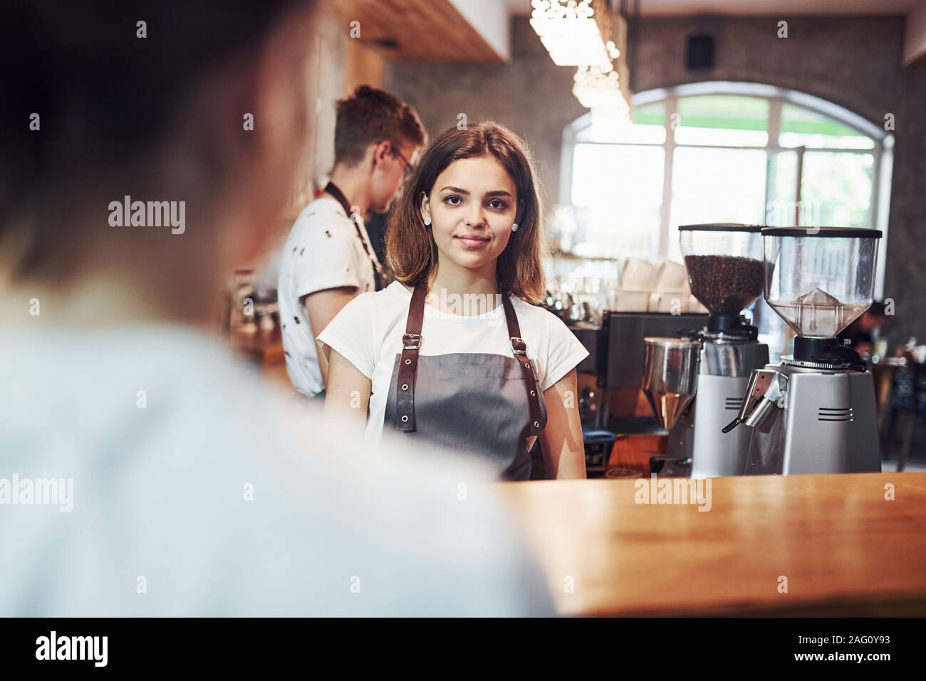 Customer service. Two young cafe workers indoors. Conception of ...