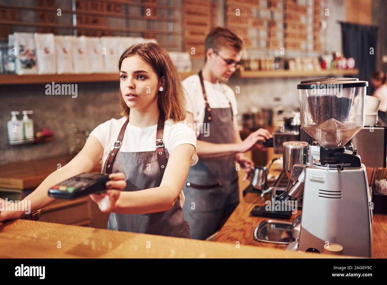 Customer service. Two young cafe workers indoors. Conception of ...