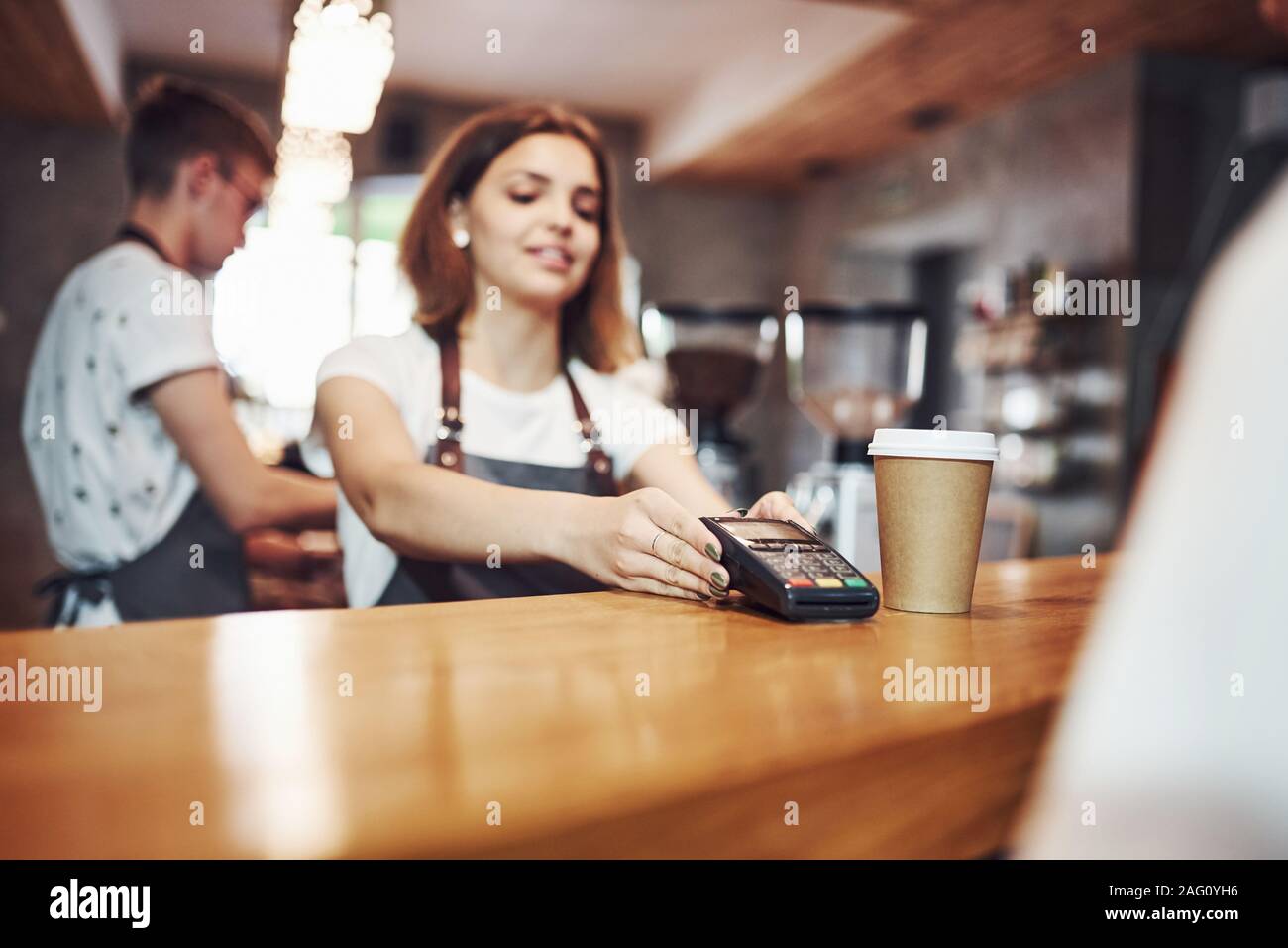 Customer service. Two young cafe workers indoors. Conception of ...
