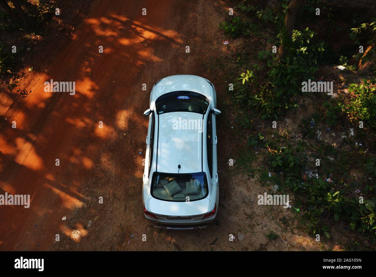 Close up of top view of a white Indian car standing in a forest in the ...