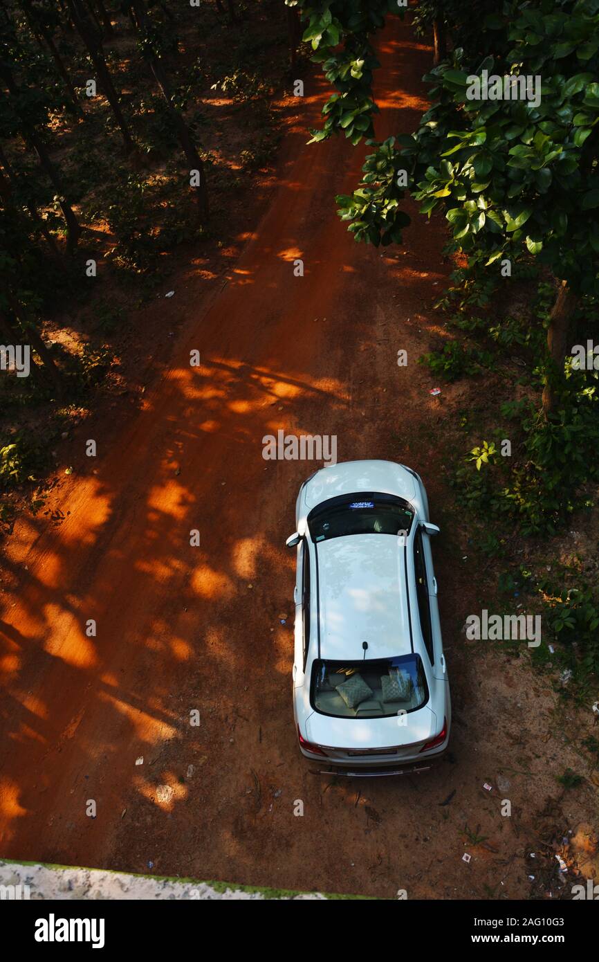 Close up of top view of a white Indian car standing in a forest in the ...