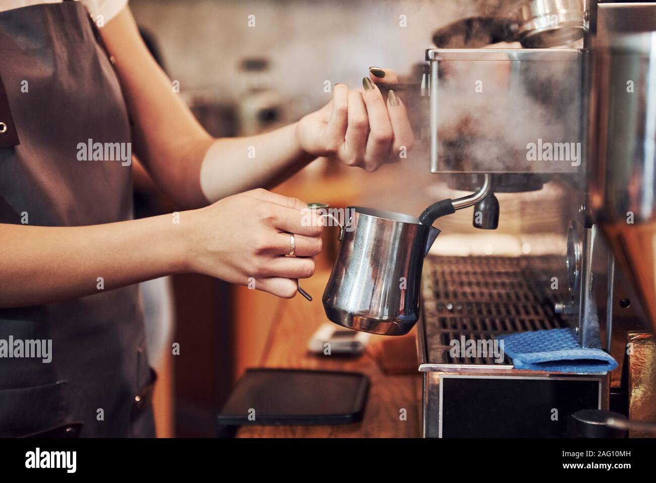 That's how fresh drink makes. Young female cafe worker indoors ...