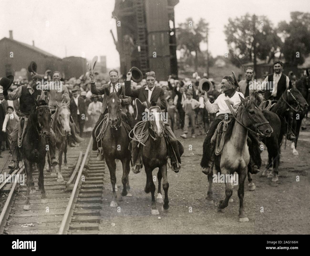Early 20th century vintage press photograph - cheering cowboys ride ...