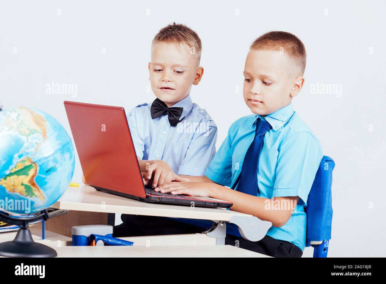 study on the computer two boys at school Stock Photo - Alamy