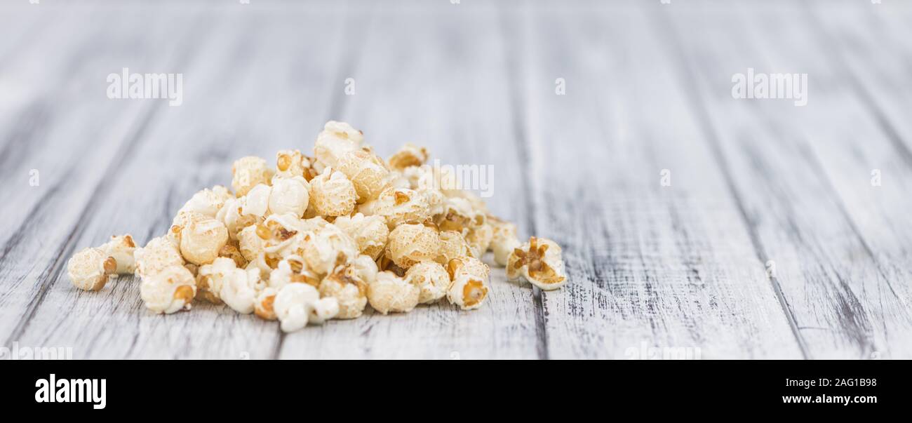 Fresh made Popcorn on a vintage background as detailed close-up shot ...