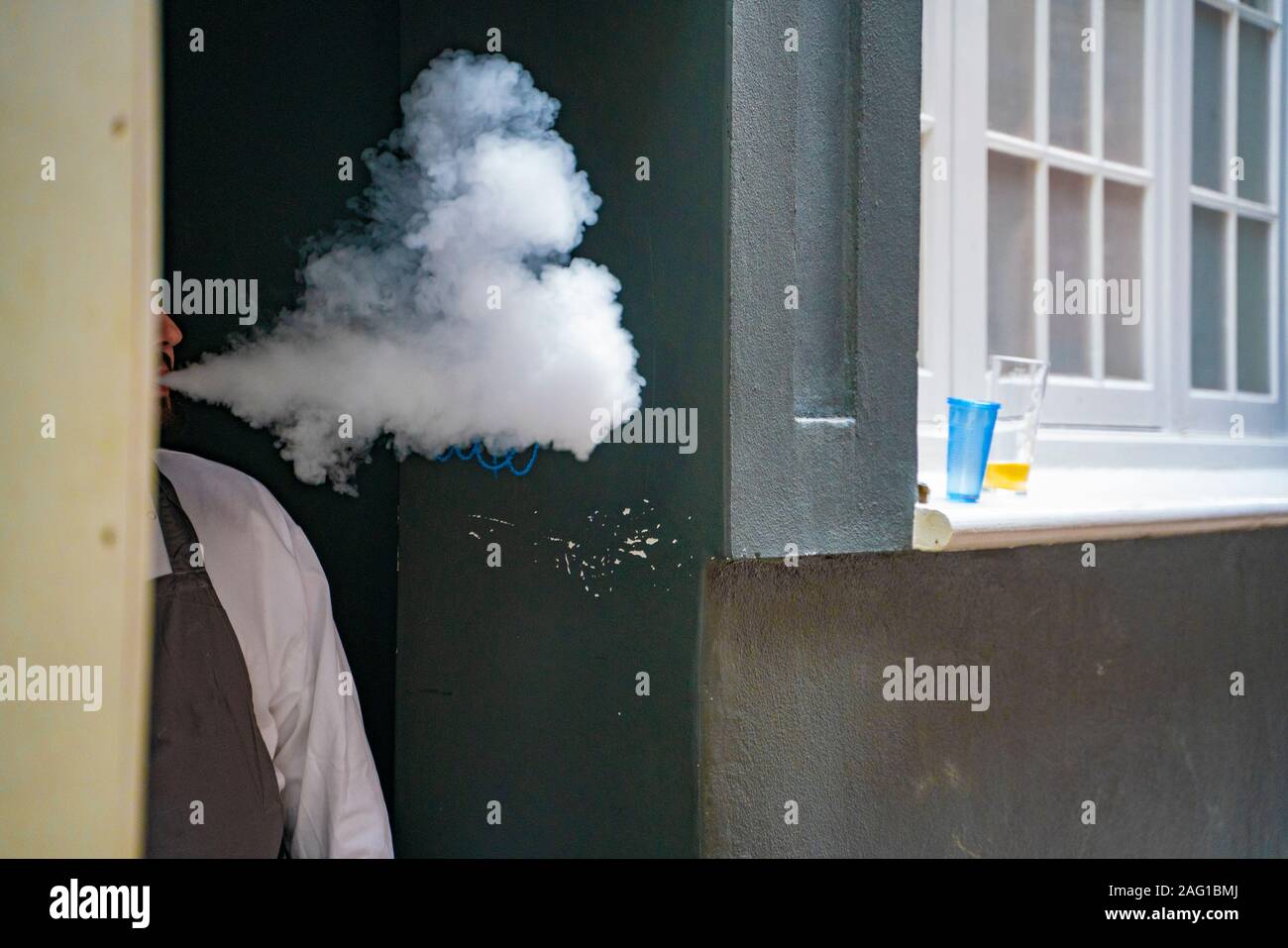 Man Blowing Out Vapour Stock Photo - Alamy