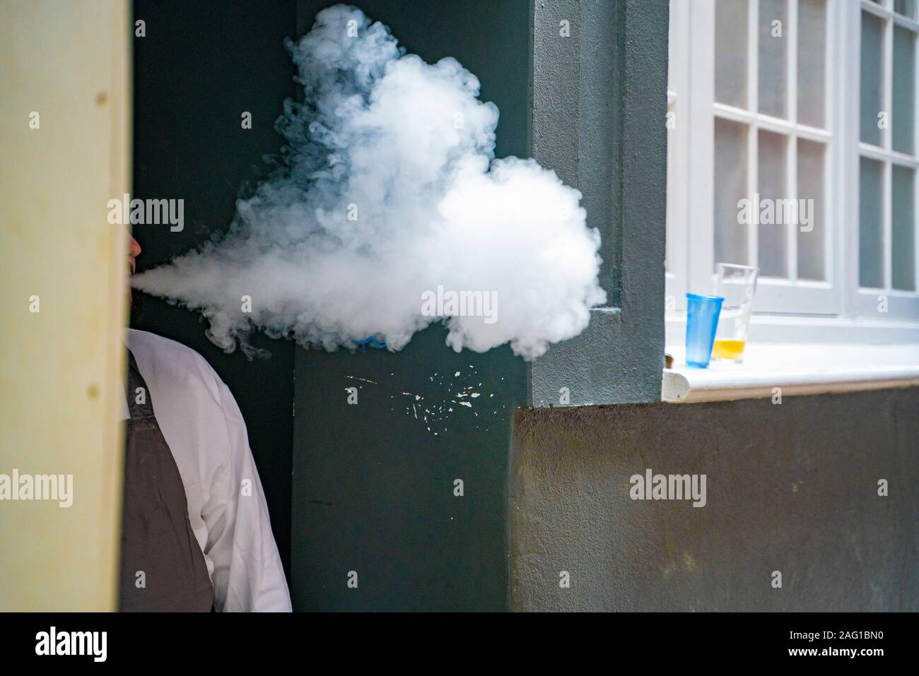 Man Blowing Out Vapour Stock Photo - Alamy