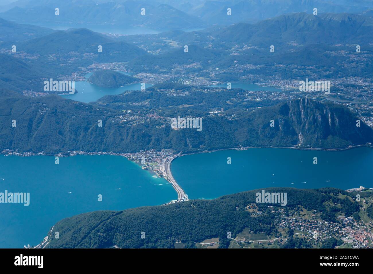 aerial, from a small plane, of highway and railway bridge on Lugano ...