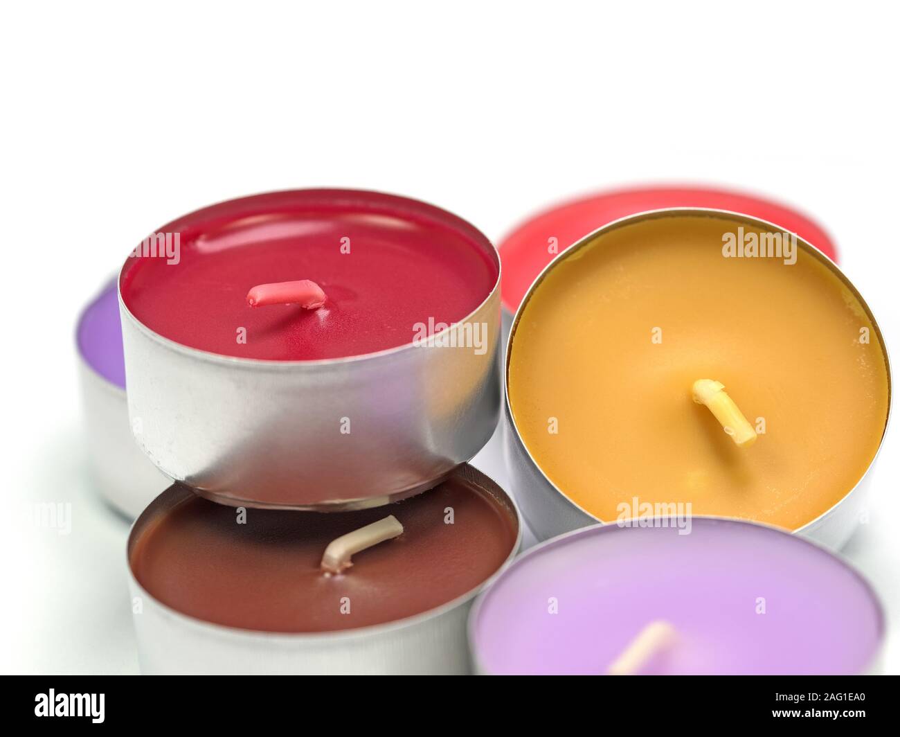 Colorful tea lights against white background Stock Photo - Alamy