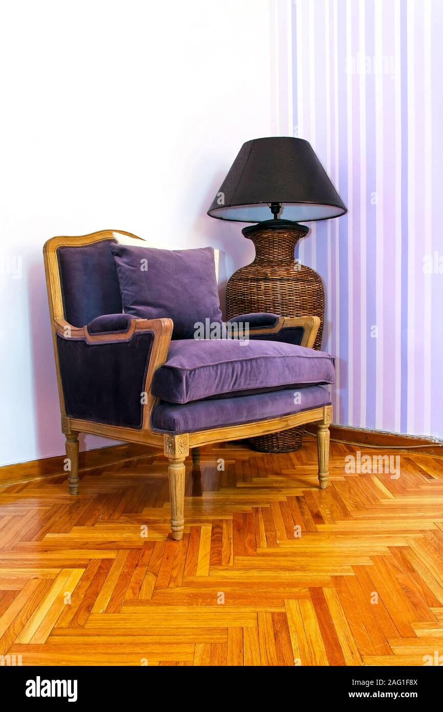 Reading room with vintage style purple armchair Stock Photo - Alamy