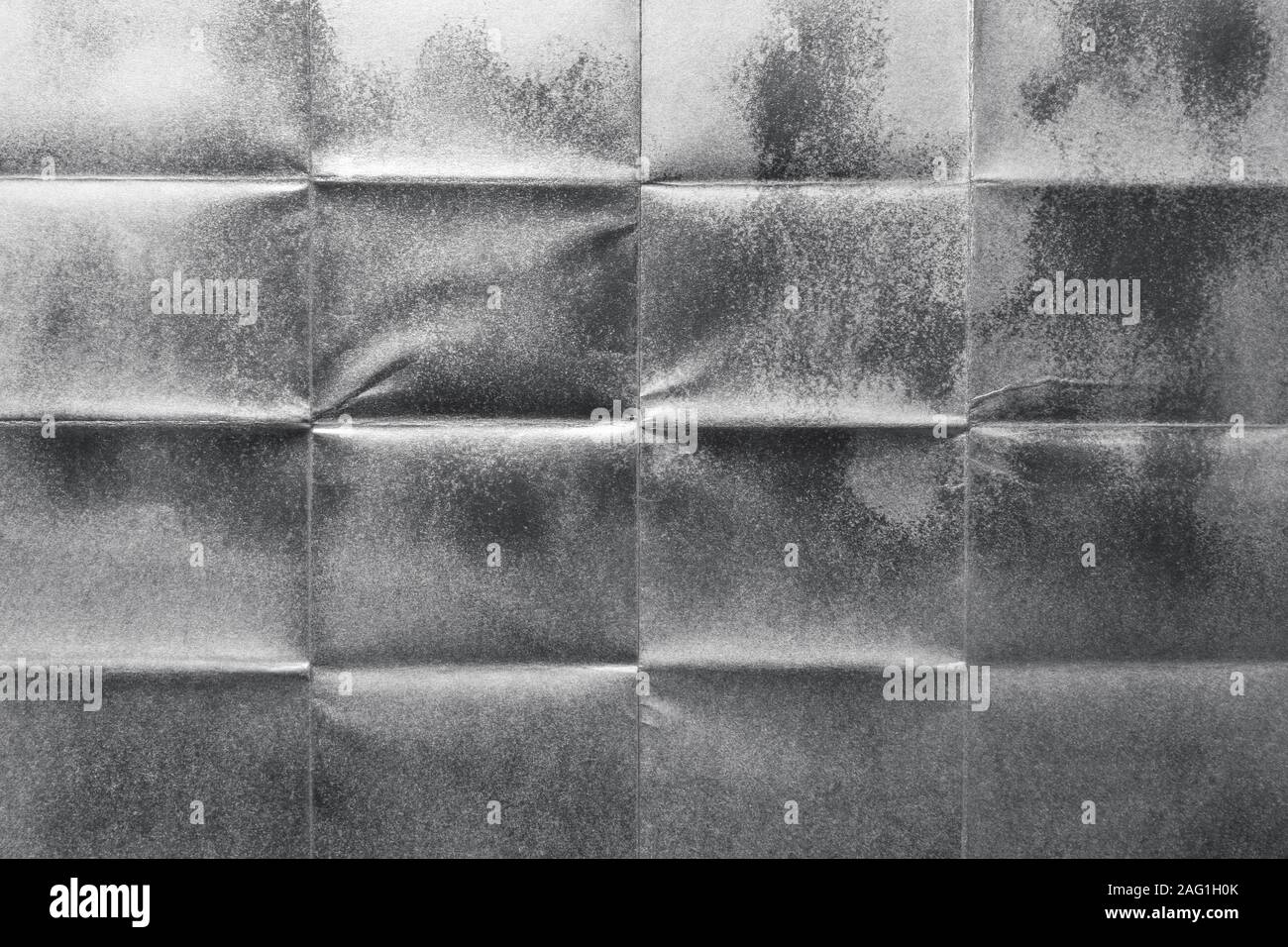 Silver paper folded in sixteen, texture background Stock Photo - Alamy