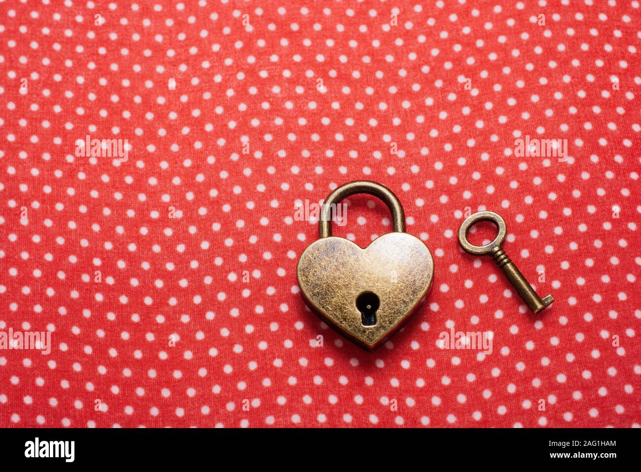 Heart shaped lock and key on a red background Stock Photo - Alamy