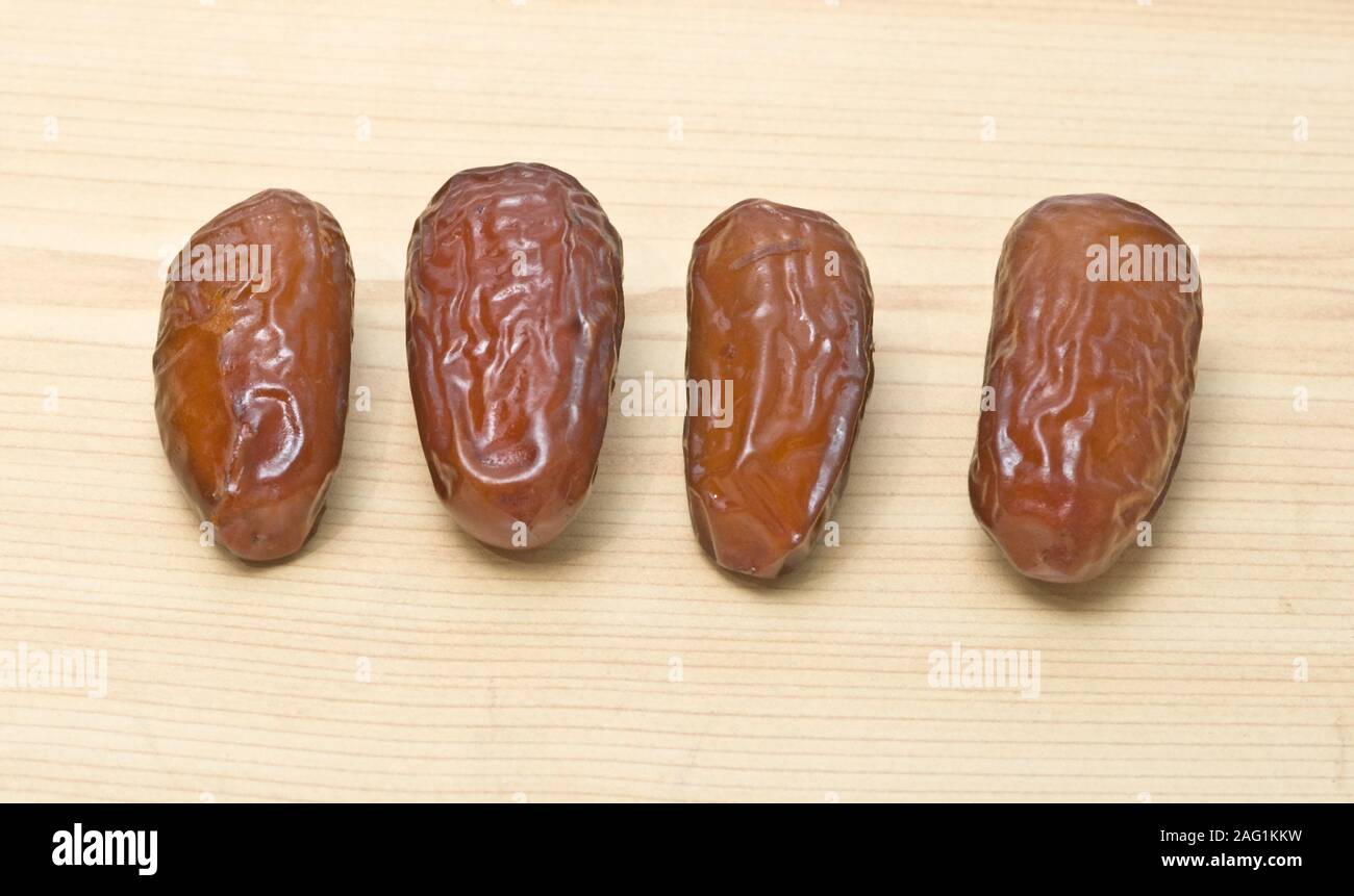 Dried dates isolated on white background Stock Photo - Alamy