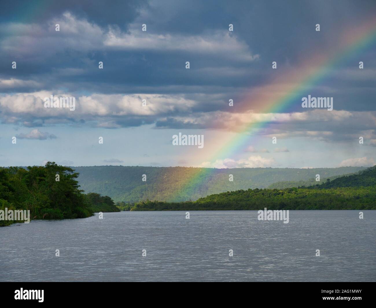 After heavy rain a rainbow forms over the river at Tatai in Koh Kong ...