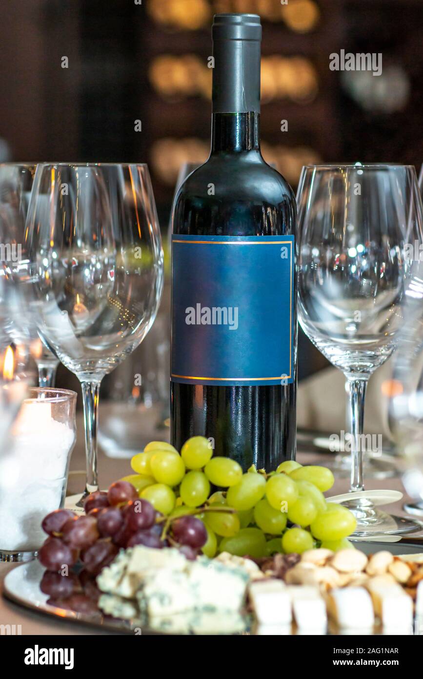 Wine bottle and cheese variety for snack Stock Photo - Alamy