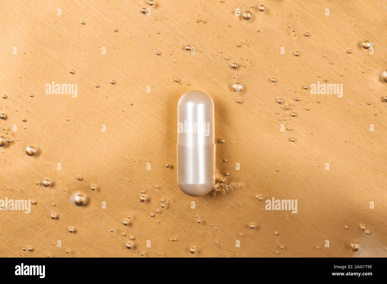 Beauty capsule on backdrop with cosmetic oxygen bubbles, macro Stock ...