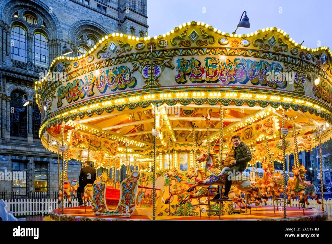 Man and child enjoying carousel ride, London, England, UK Stock Photo ...