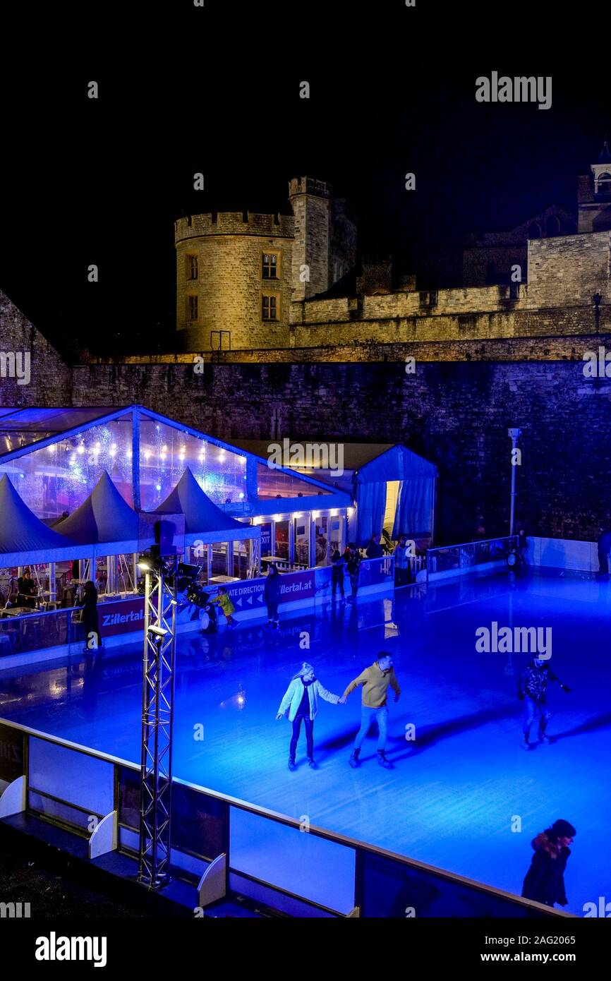 Couple ice skating, Tower of London, castle at night, London, England ...