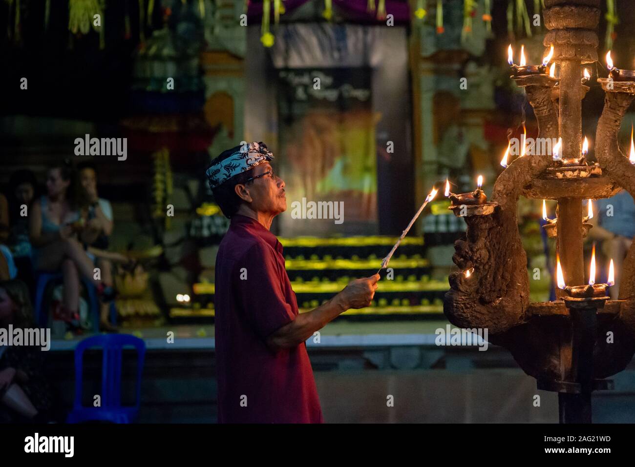 Ubud, Bali, Indonesia - September 3, 2017: Man lighting candles at the ...