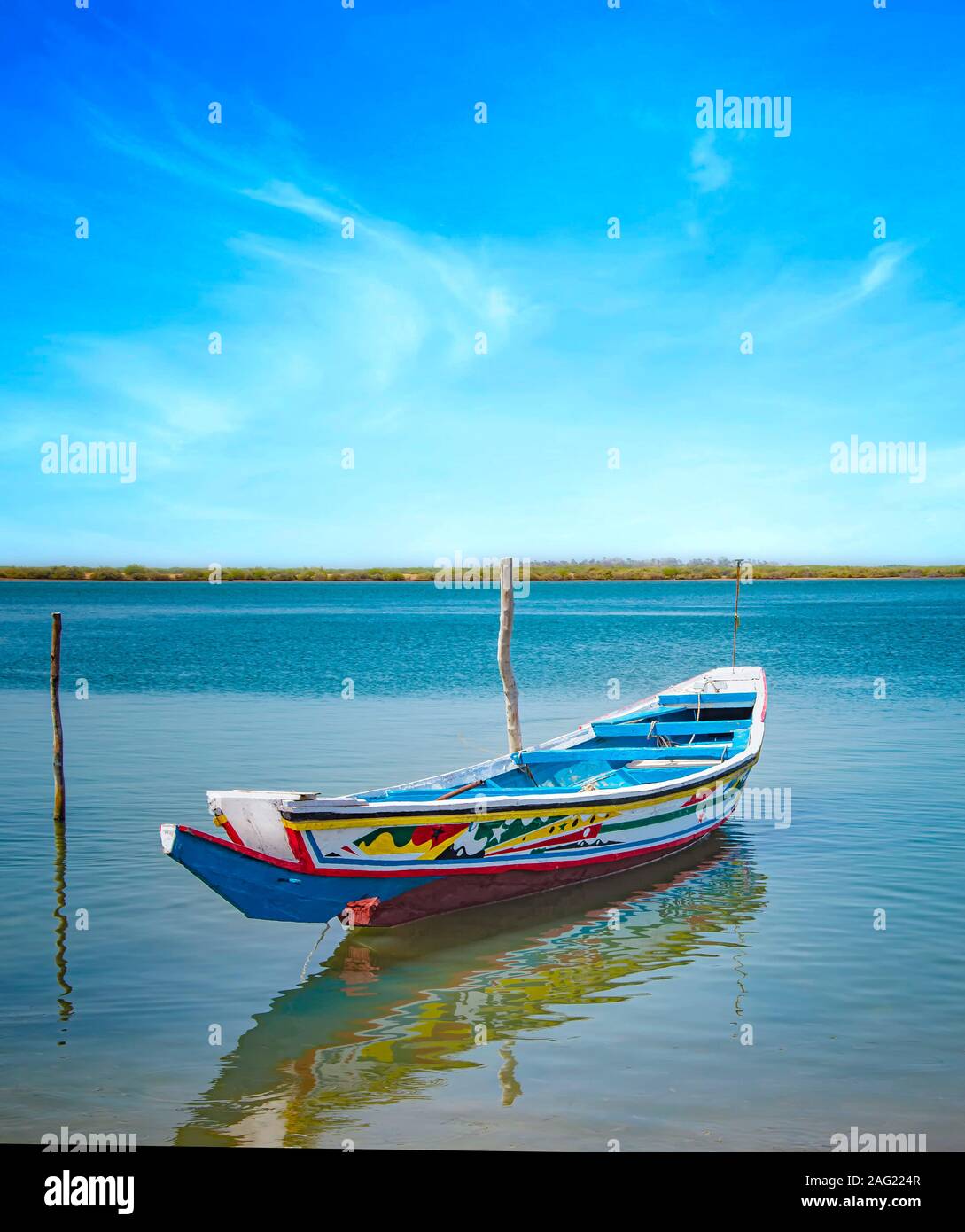 Traditional colorful wooden boat on the river in sea lagoon and a ...