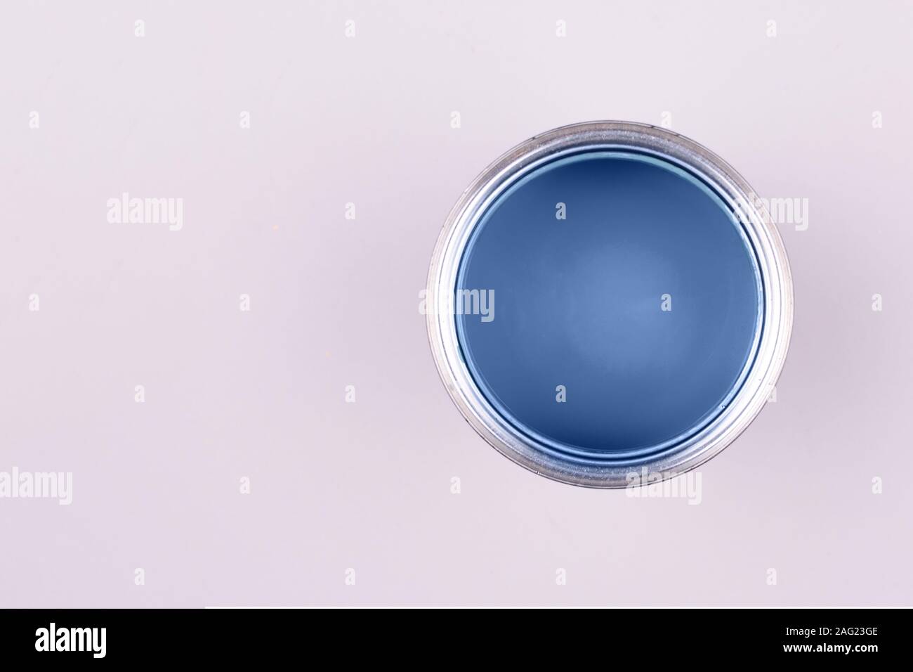 can filled with blue paint on hell background. Classic blue color of ...