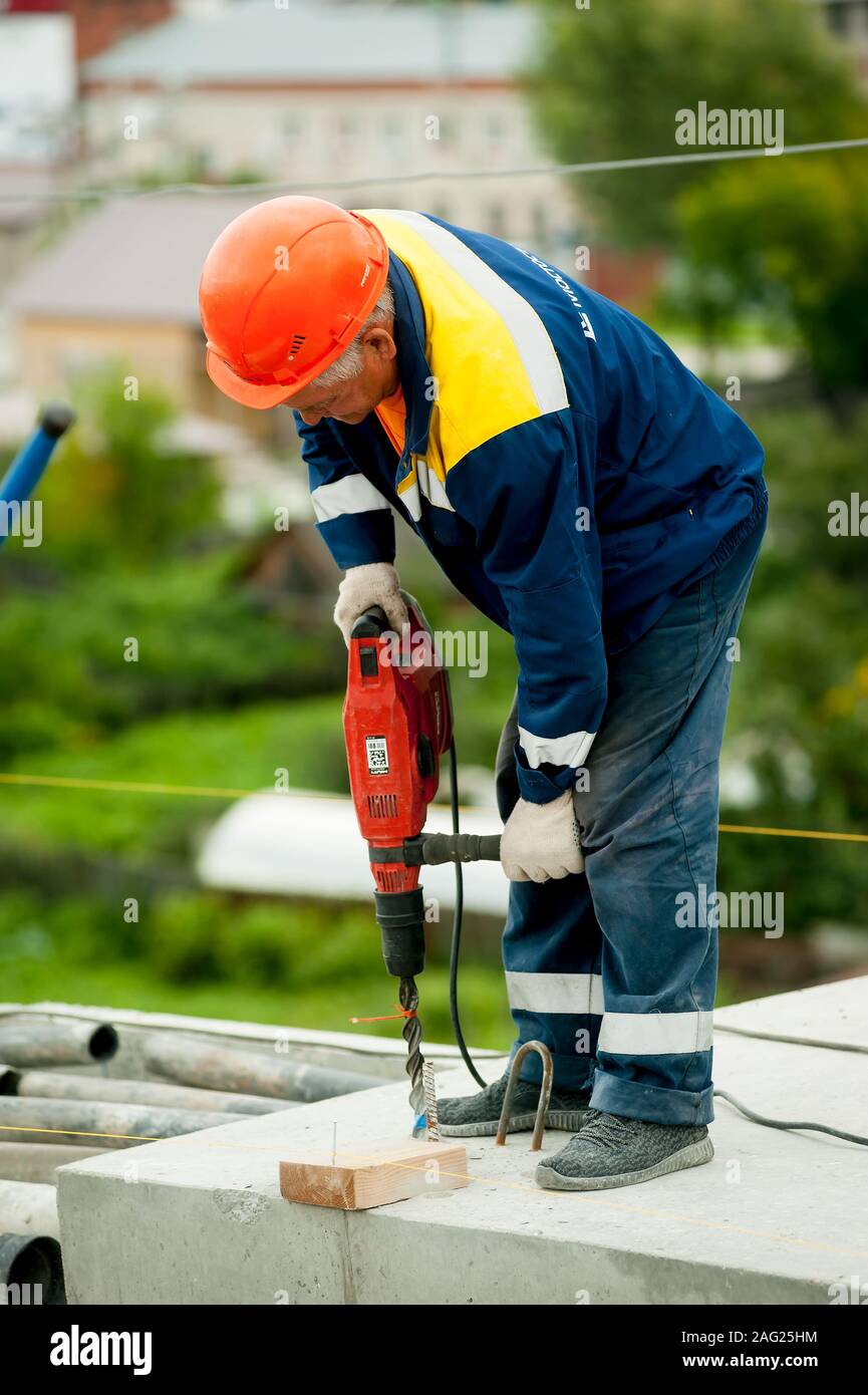 Worker drilling concrete at construction site Stock Photo - Alamy