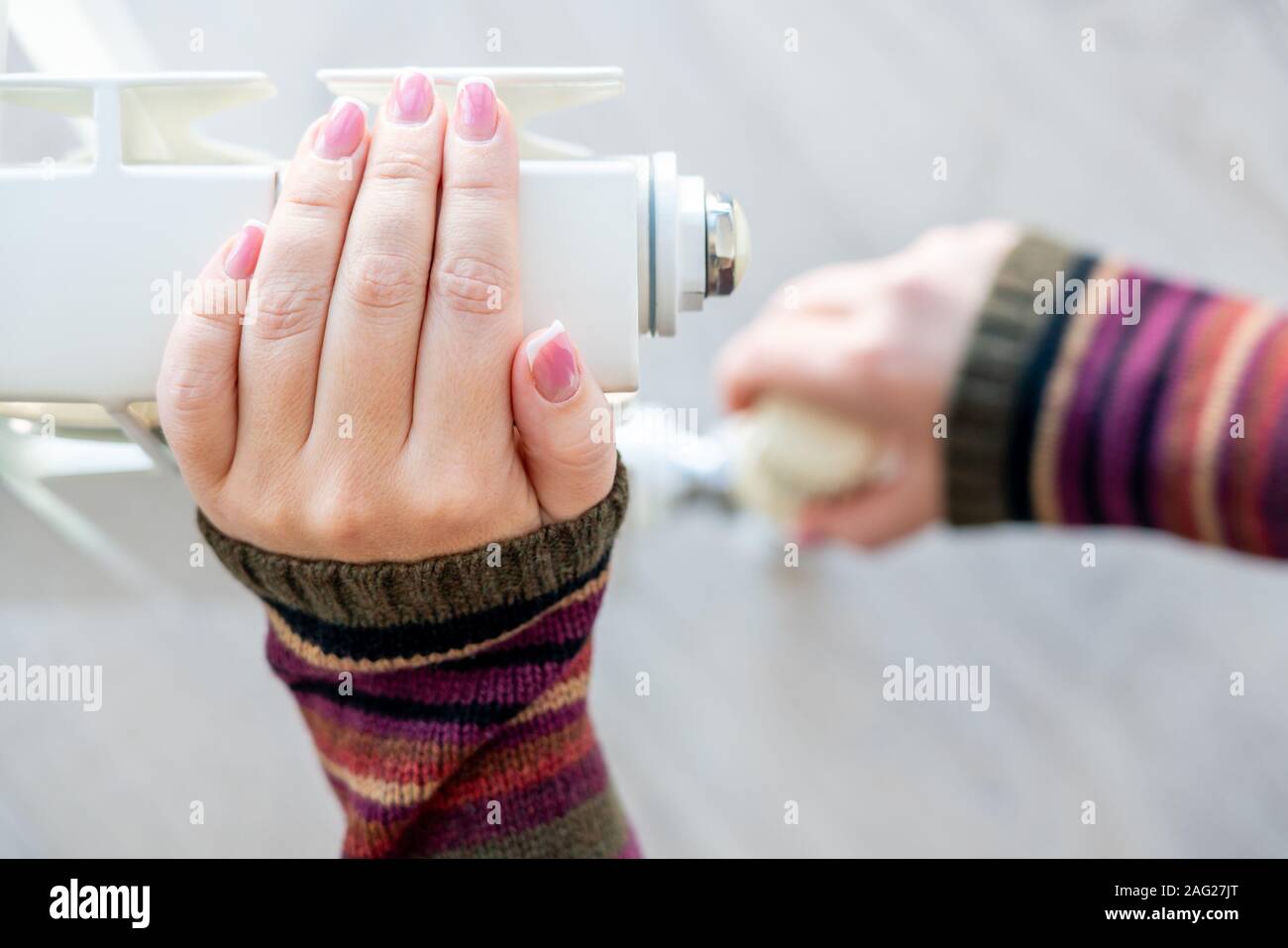 Radiator adjustment closeup, Female hand adjusting radiator temperature ...