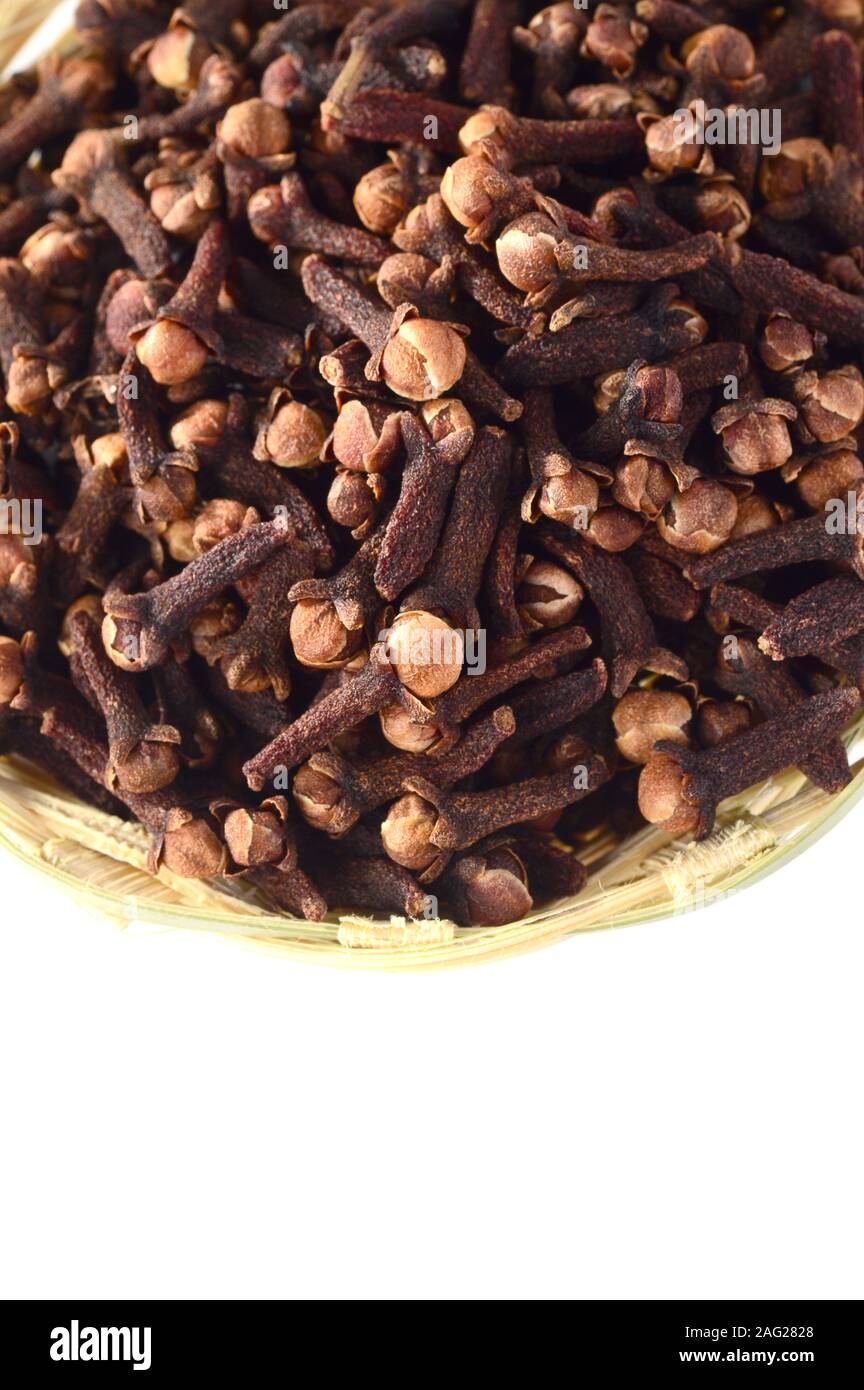 Cloves (spice) in bamboo basket isolated on white background Stock ...