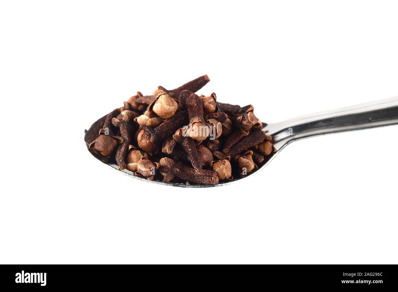 clove in spoon isolated on a white background Stock Photo - Alamy