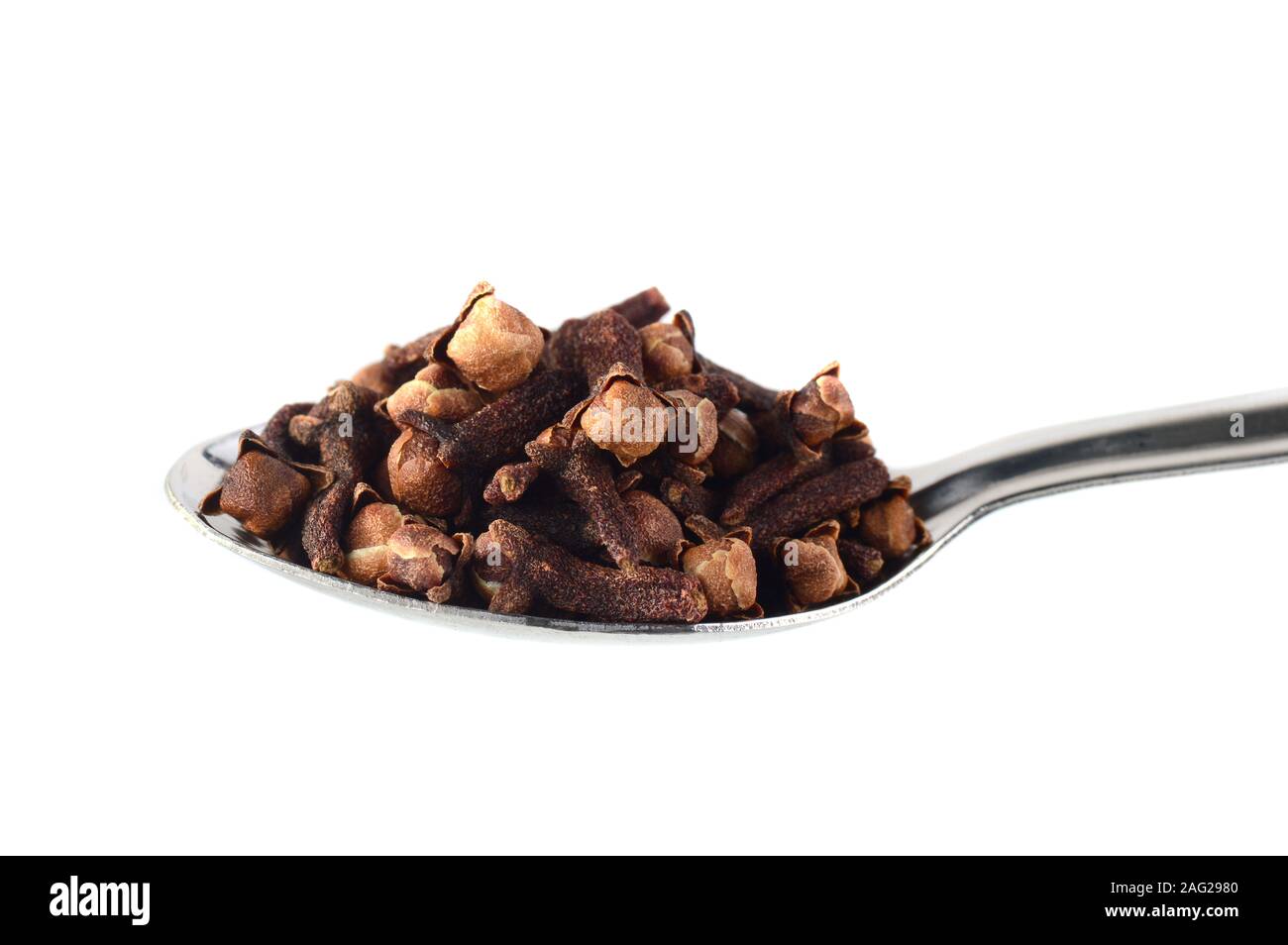 clove in spoon isolated on a white background Stock Photo - Alamy