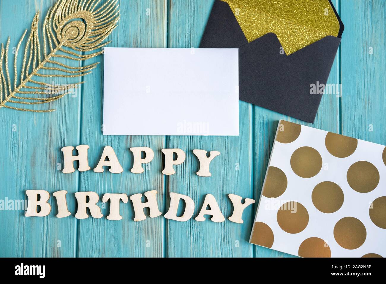 Inscription Happy Birthday from wooden letters with a notebook, a pen ...