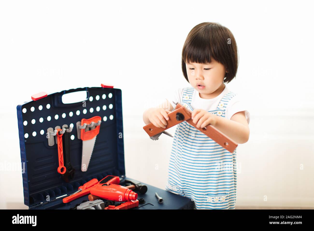 toddler baby girl pretend play DIY tools Stock Photo - Alamy