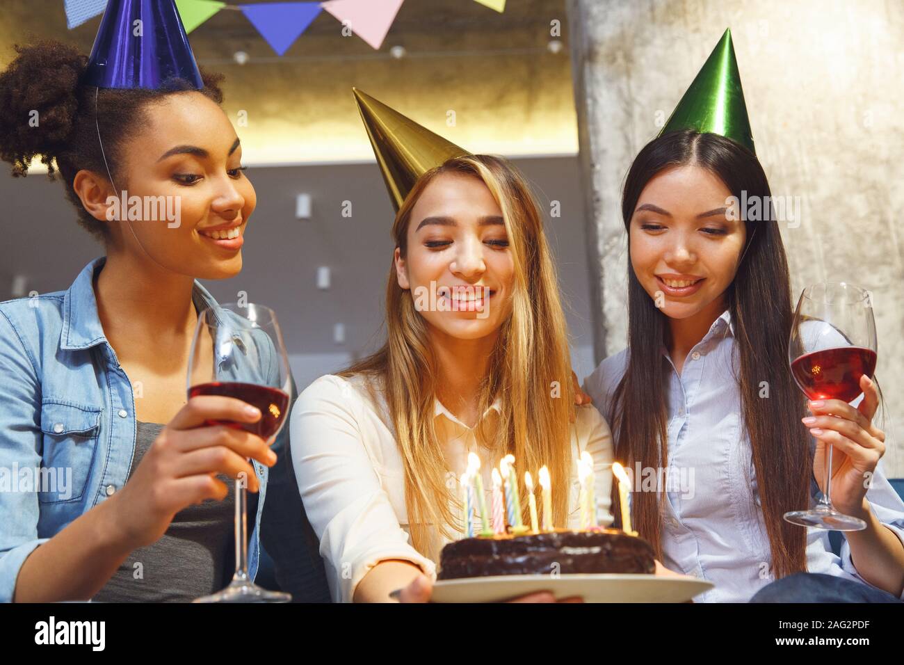 Group of friends having party indoors fun together birthday wish Stock ...