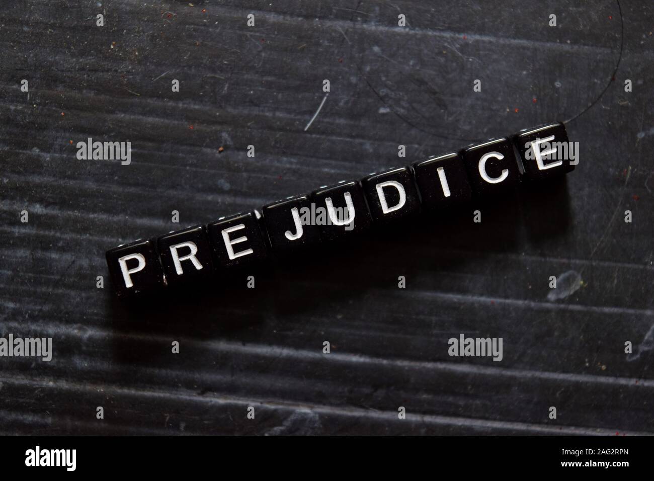 Prejudice on wooden cubes. On table background Stock Photo - Alamy