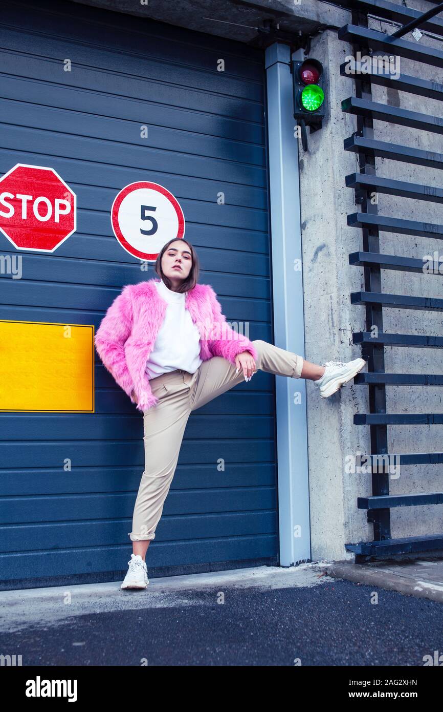 young cute girl teenager gesturing hanging around city parking and ...
