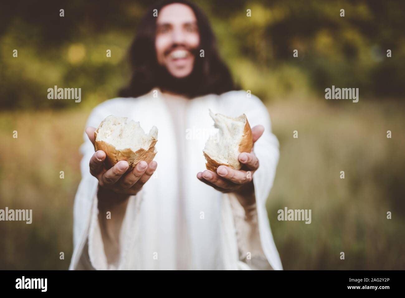 Shallow focus shot of Jesus Christ giving out a sliced breads Stock ...