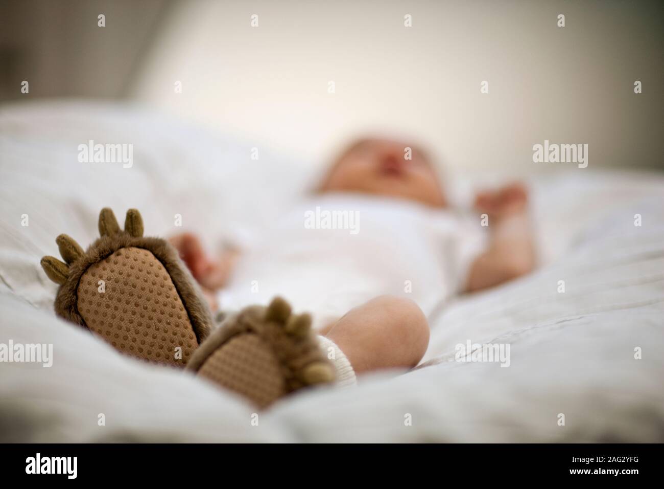 Baby wearing booties hi-res stock photography and images - Alamy